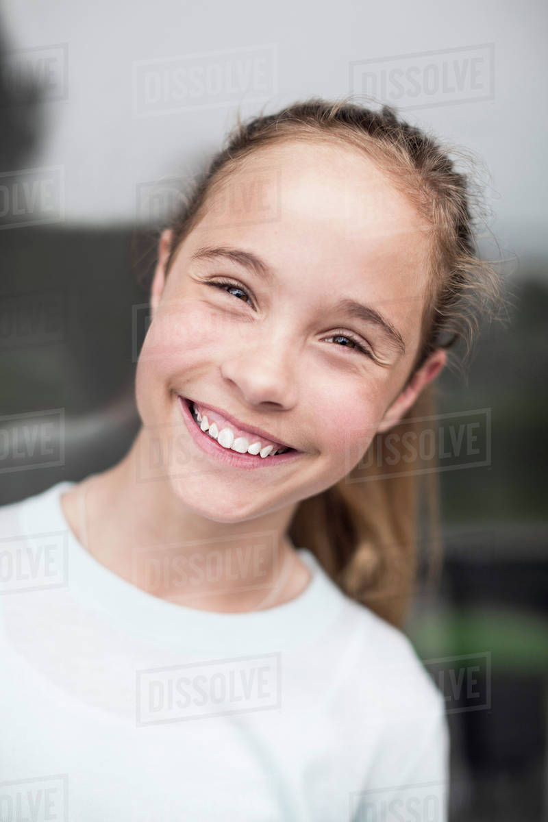 Portrait of happy girl outdoors - Stock Photo - Dissolve