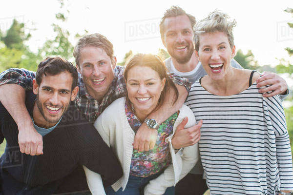 Group portrait of happy friends enjoying picnic at lakeshore - Royalty ...