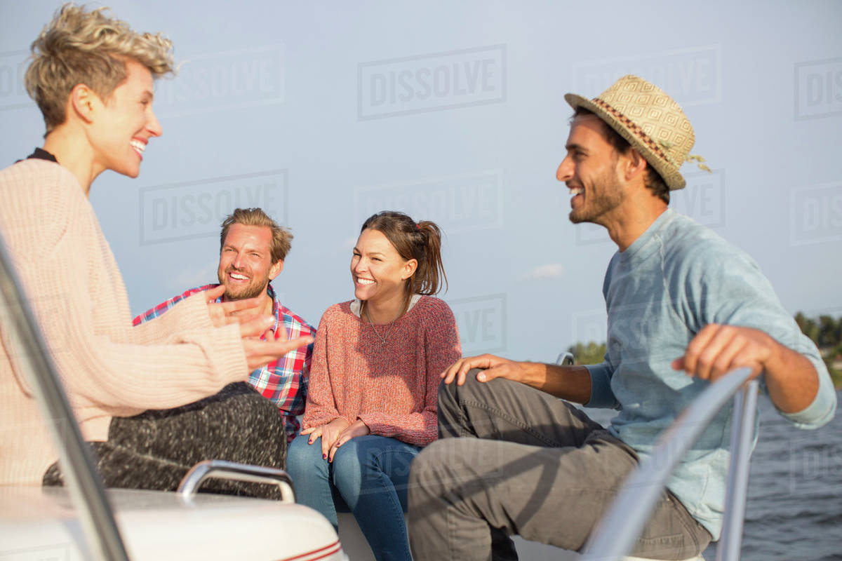 Happy friends communicating on yacht - Royalty-free Stock Photo | Dissolve