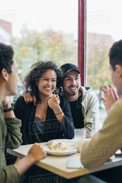 Happy university students in cafe - Royalty-free Stock Photo | Dissolve