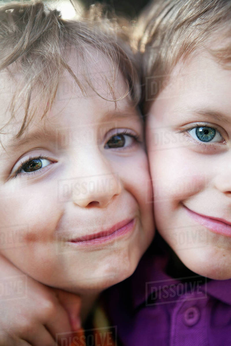 Close-up portrait of a two brothers smiling - Stock Photo - Dissolve