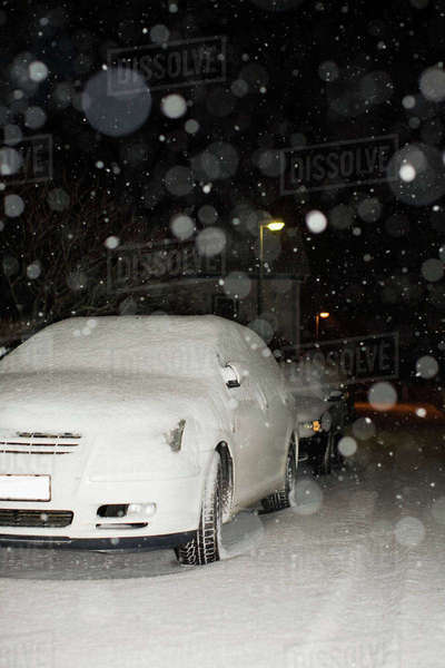 Snow covered cars parked on street at night - Royalty-free Stock Photo ...