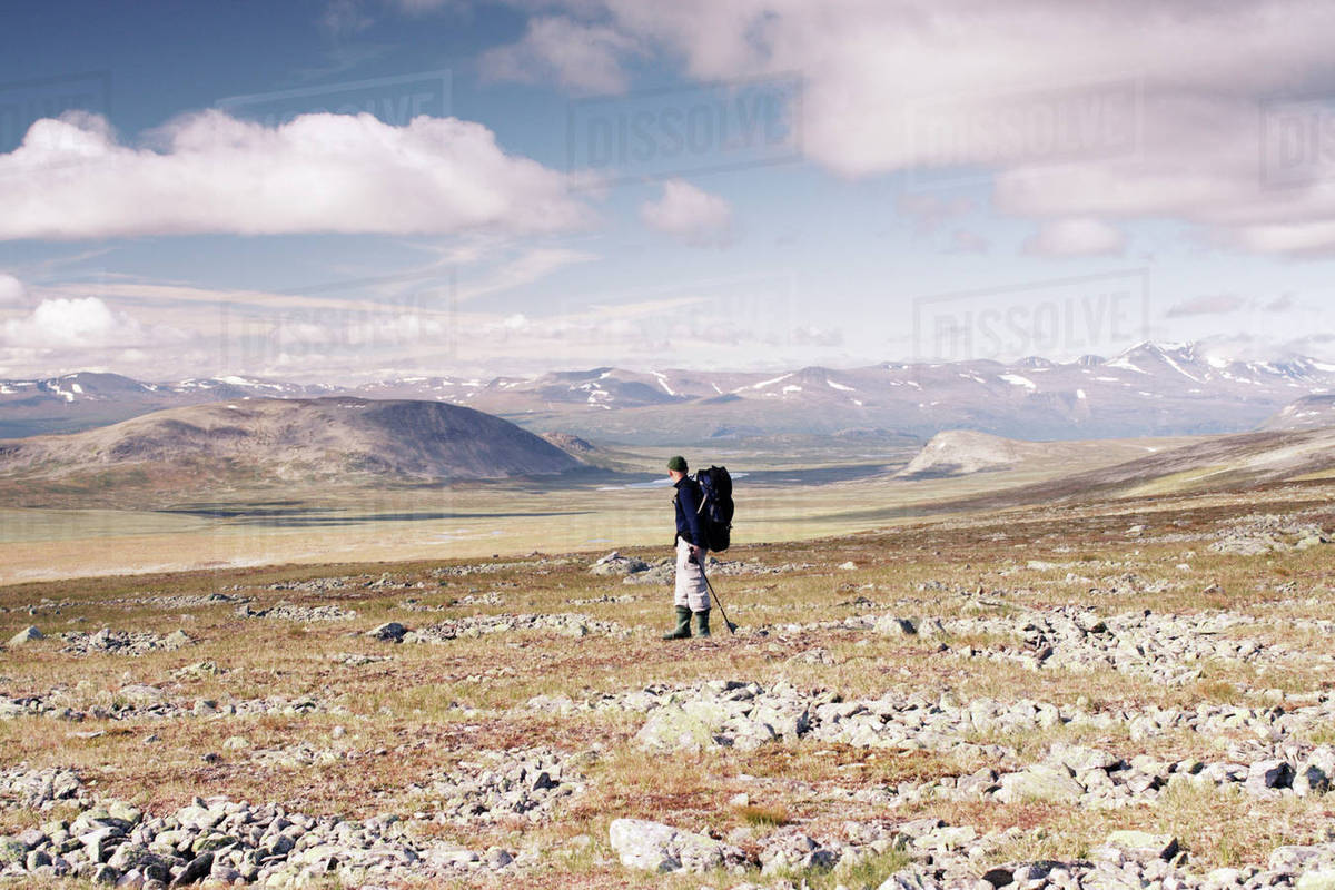 Man standing on landscape against sky - Stock Photo - Dissolve