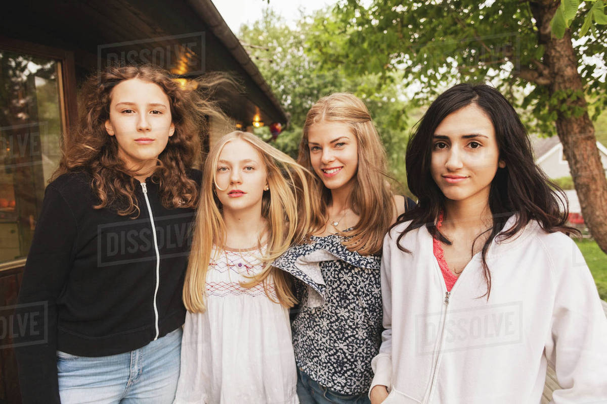 Portrait of happy teenage girls standing at yard - Royalty-free Stock ...