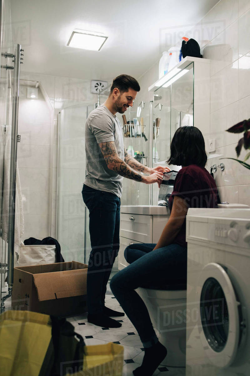 Man and woman unpacking in bathroom at new home - Royalty-free Stock ...