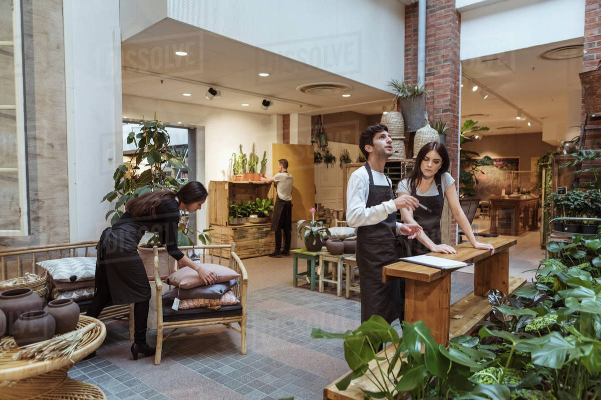 Male and female colleagues working at store - Stock Photo - Dissolve