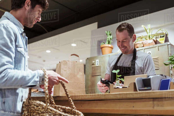 Customer paying cashier at checkout counter - Royalty-free Stock Photo ...