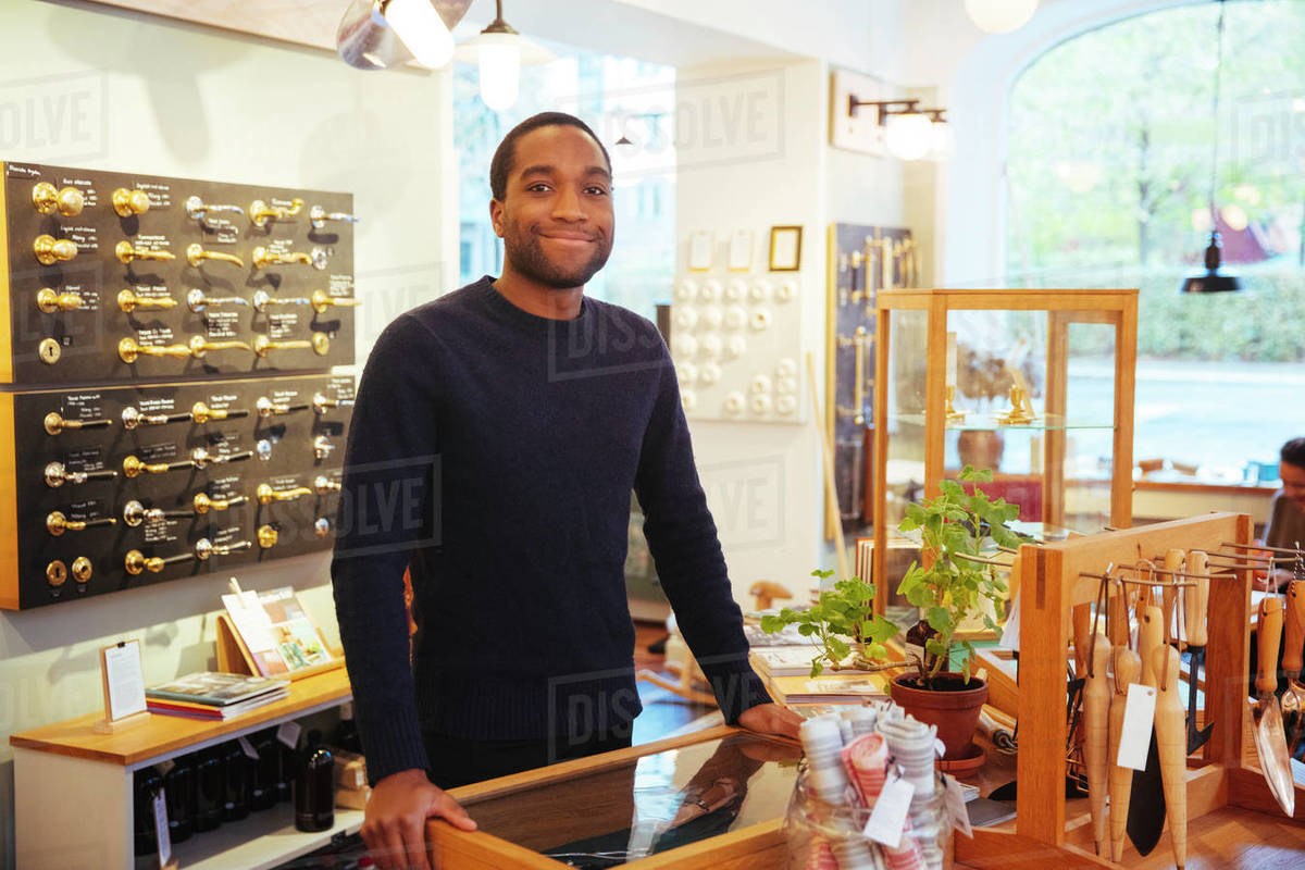Portrait of smiling young owner standing at furniture store - Royalty ...