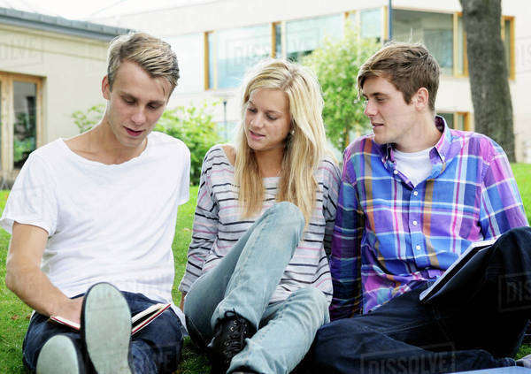 Students sitting outside reading - Royalty-free Stock Photo | Dissolve