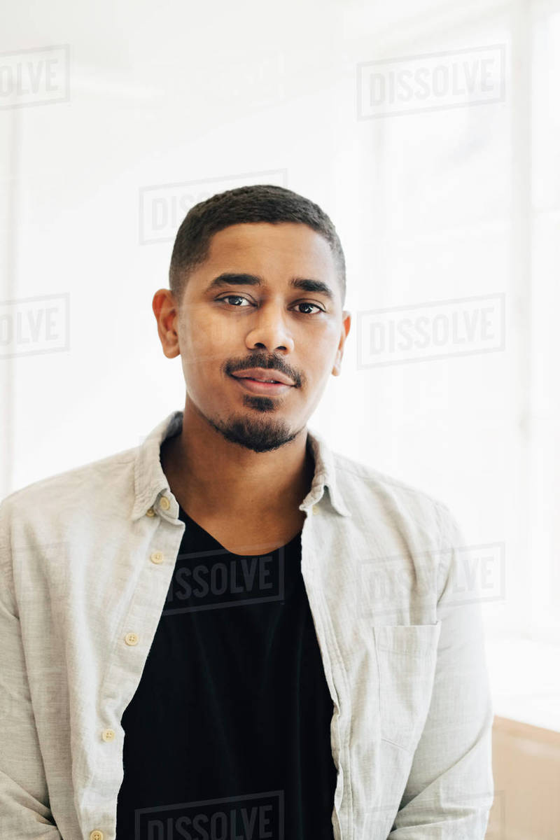 Portrait of male computer programmer standing in office - Royalty-free ...