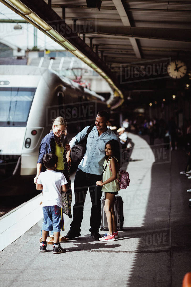 Family greeting man at railroad station - Royalty-free Stock Photo ...