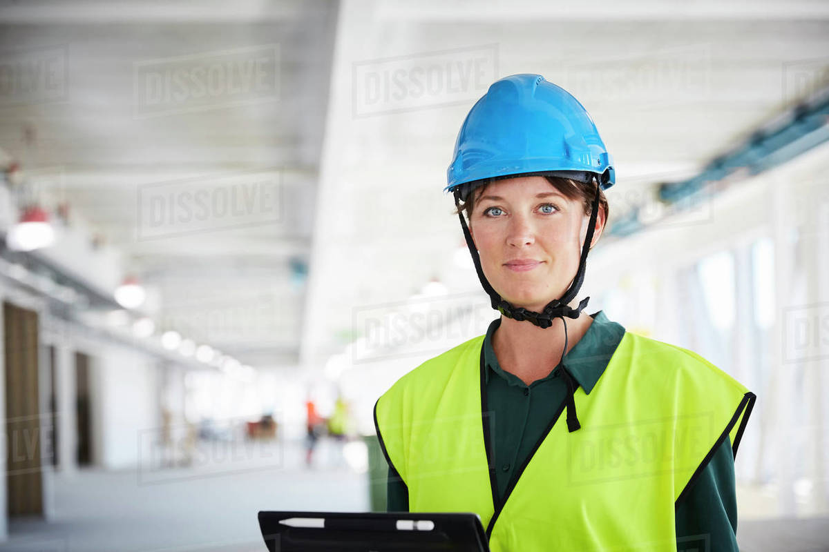 Portrait of confident female construction manager in reflective ...