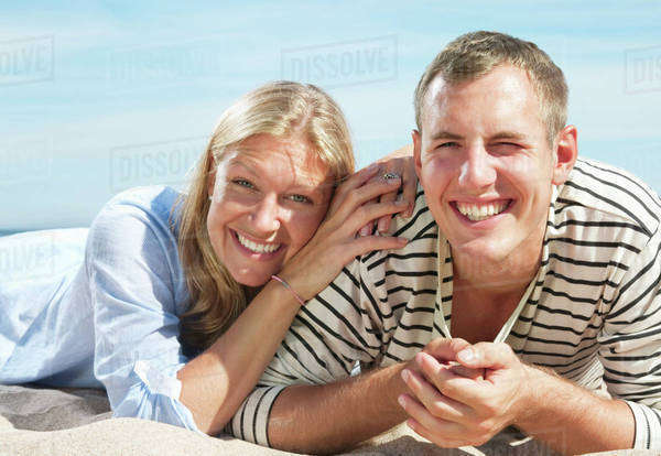 Two people lying on the beach - Royalty-free Stock Photo | Dissolve