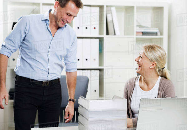 Two people talking at work - Royalty-free Stock Photo | Dissolve