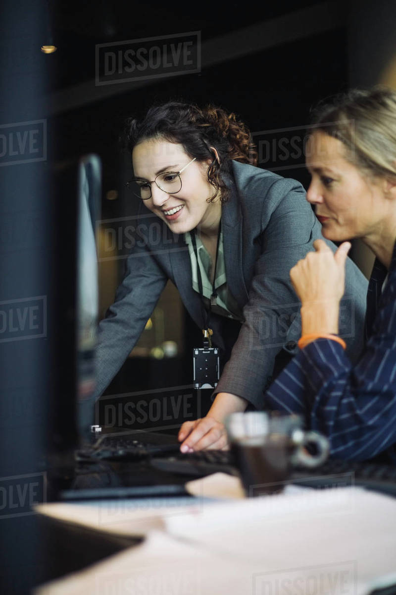 Smiling female IT professionals working on computer in office - Royalty ...