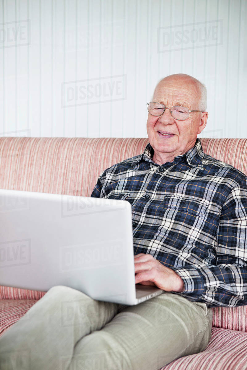 Elderly man with laptop - Royalty-free Stock Photo | Dissolve