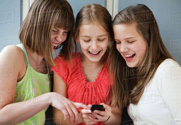 Three friends finds something funny - Royalty-free Stock Photo | Dissolve