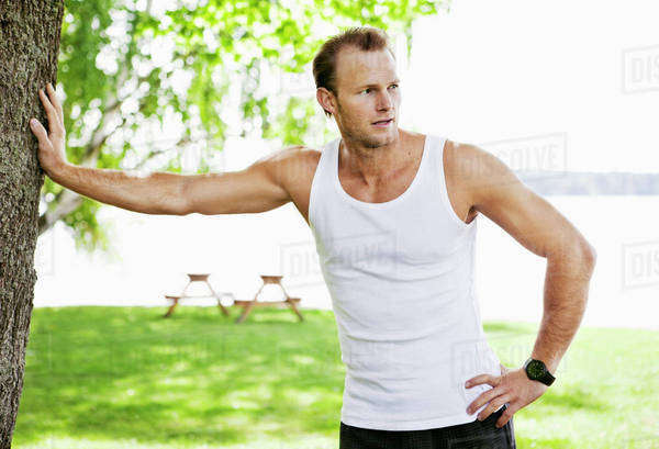 Man leaning against a tree 2 - Stock Photo - Dissolve