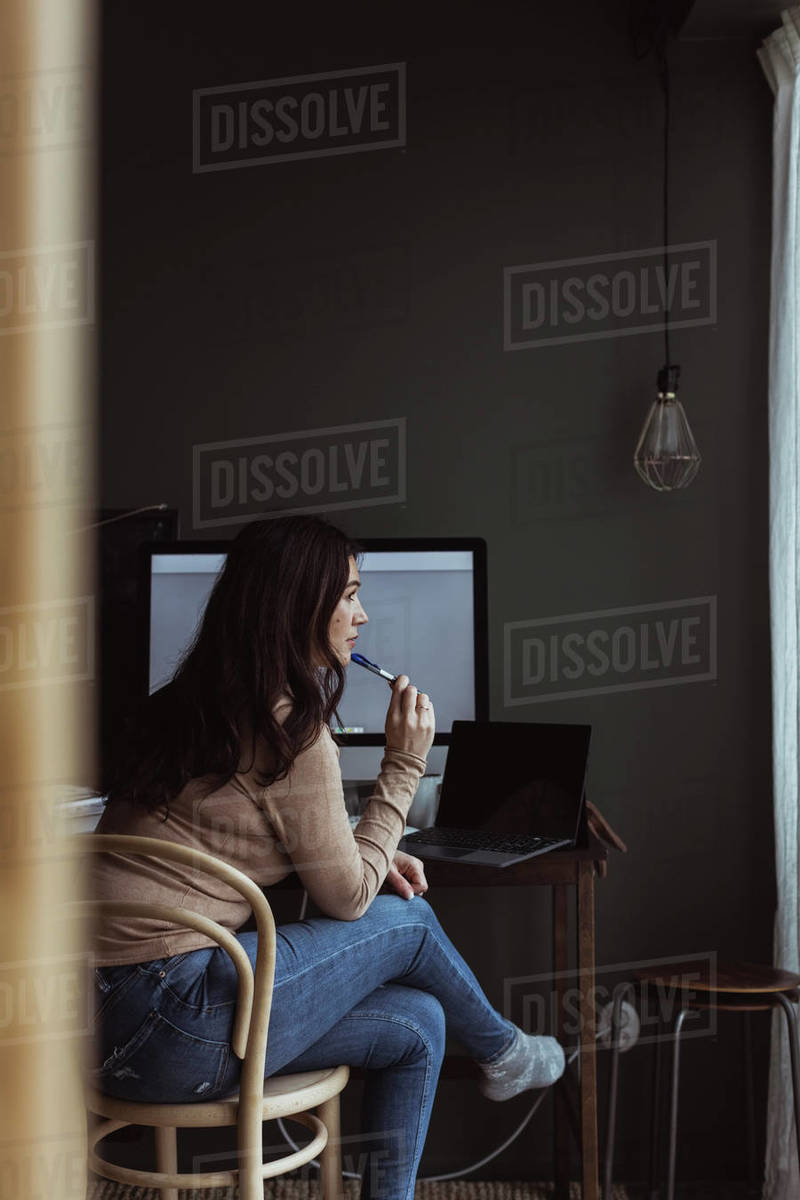 Female professional thinking while working at home office - Stock Photo ...