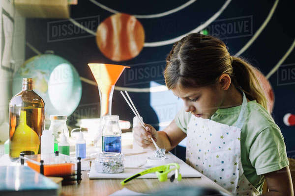Motivated female scientist doing experiment at table - Stock Photo ...
