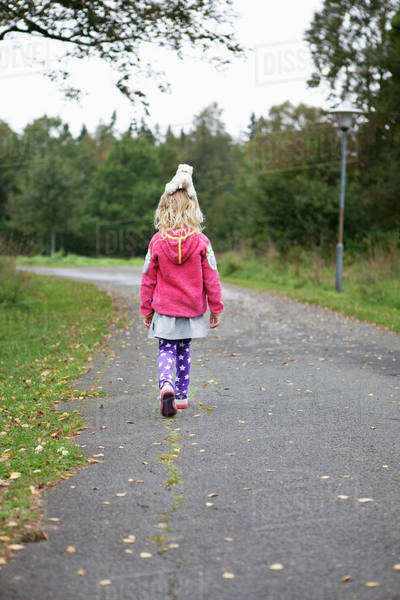 Girl walking on path - Stock Photo - Dissolve