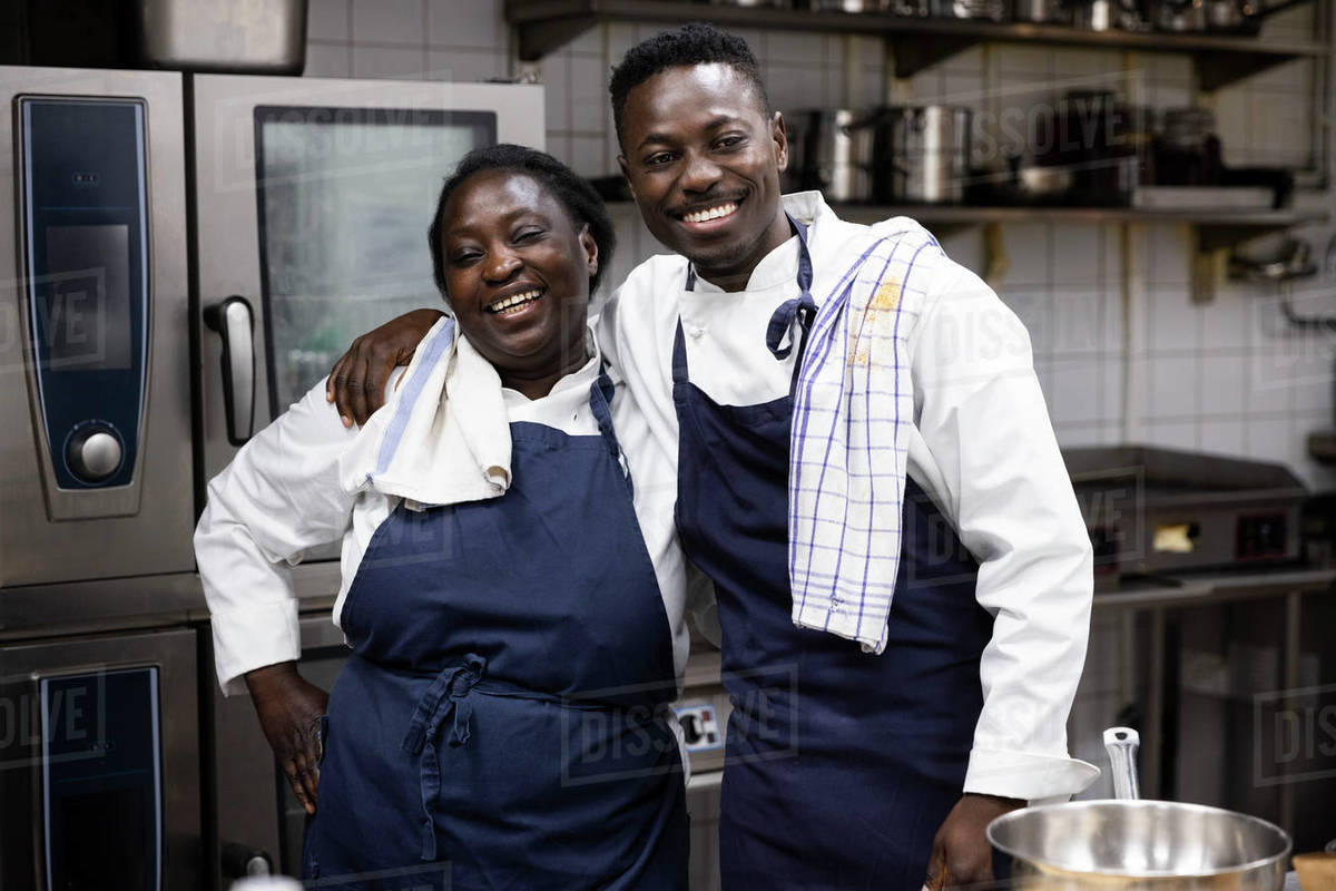 Happy chefs standing together in restaurant kitchen - Stock Photo ...