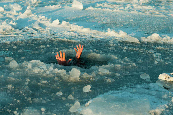 Man in ice hole - Stock Photo - Dissolve