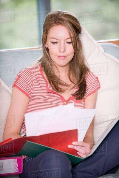 A female checking some notes - Royalty-free Stock Photo | Dissolve