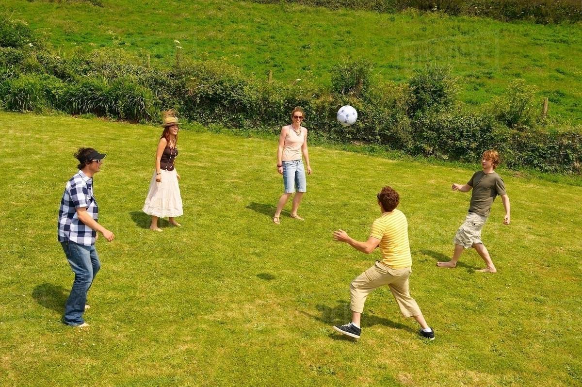 Group of five people playing football - Royalty-free Stock Photo | Dissolve
