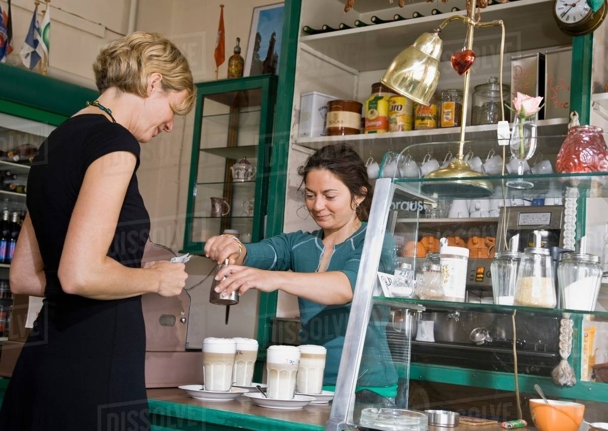 Female barista helping a female customer - Royalty-free Stock Photo ...