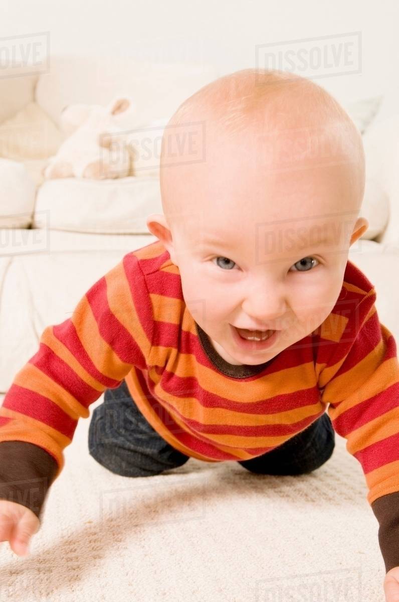 An excited baby crawling to camera. - Royalty-free Stock Photo | Dissolve
