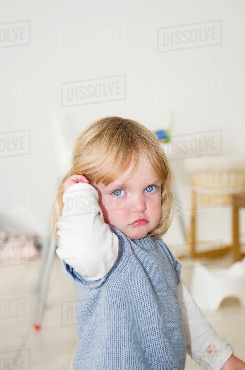 A little girl looking grumpy - Royalty-free Stock Photo | Dissolve