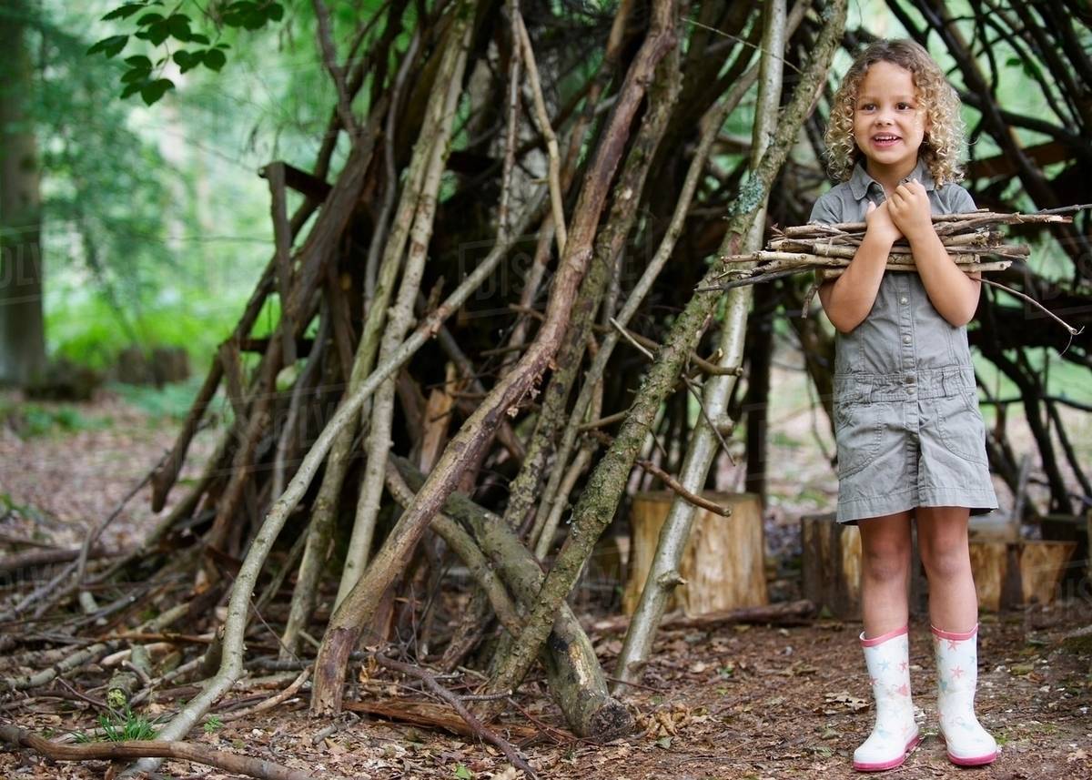 Young girl with pile of twigs in woods - Royalty-free Stock Photo ...