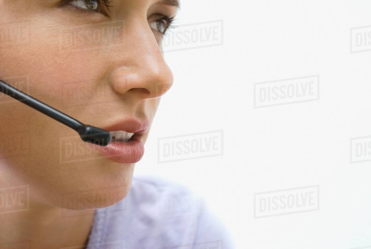 Crop of a woman on a headset - Stock Photo - Dissolve