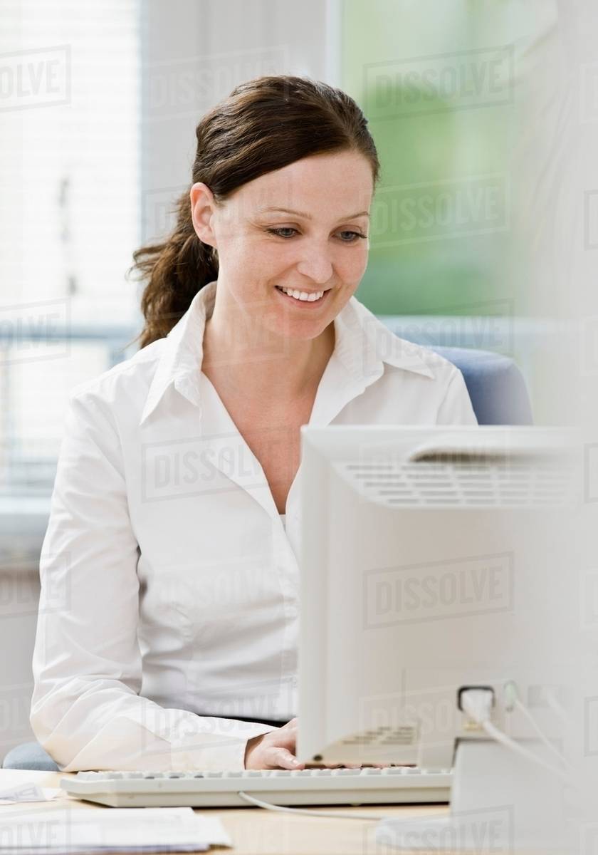 Woman working on computer - Royalty-free Stock Photo | Dissolve