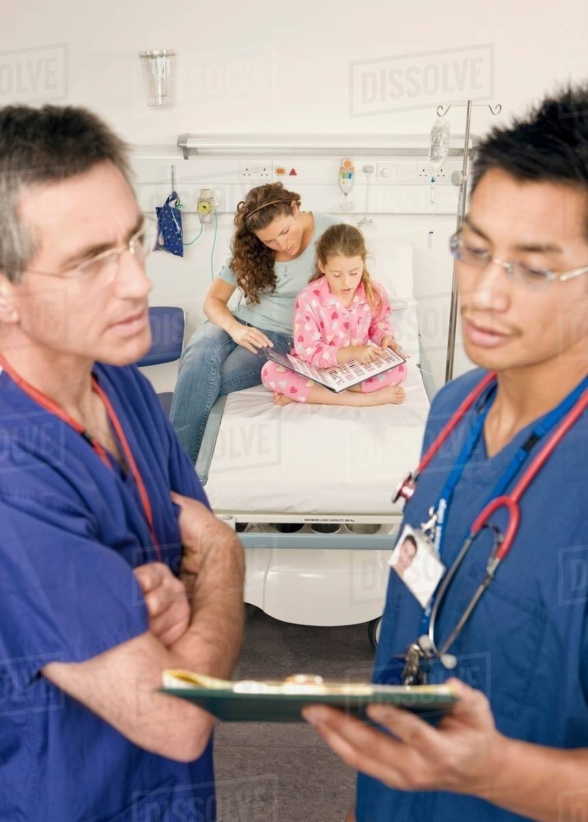 A portrait of two doctors and a patient - Stock Photo - Dissolve