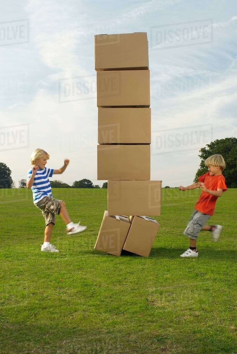 Boys kicking boxes - Royalty-free Stock Photo | Dissolve