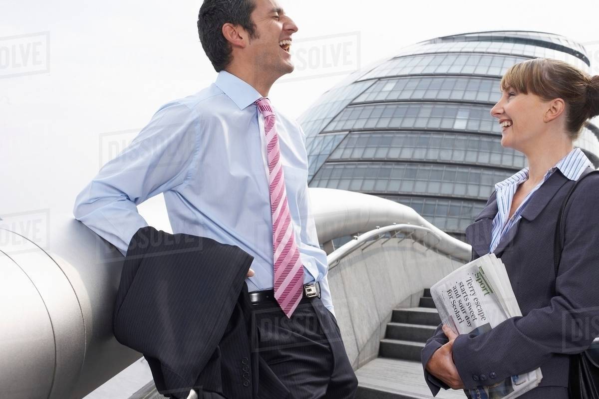 Two office workers outside talking - Royalty-free Stock Photo | Dissolve