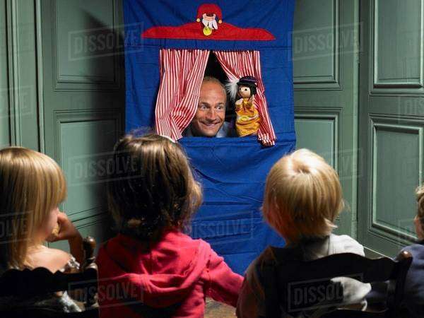 Kids watching a puppet show - Stock Photo - Dissolve