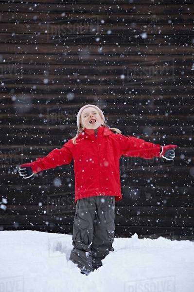 Little girl catching snowflakes - Royalty-free Stock Photo | Dissolve