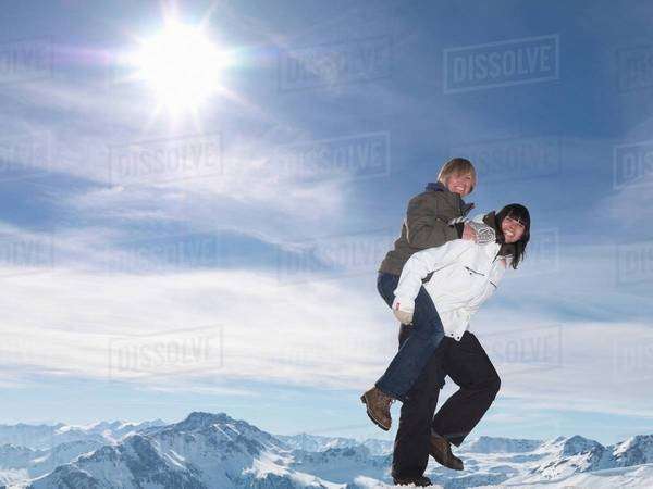 Hikers playing piggyback ride - Stock Photo - Dissolve