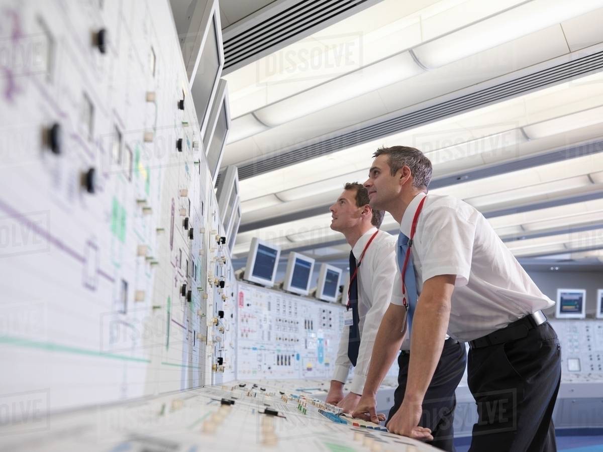 Operators working in control room - Stock Photo - Dissolve
