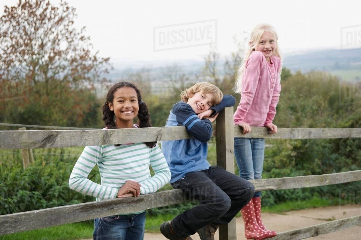 Children on fence - Royalty-free Stock Photo | Dissolve