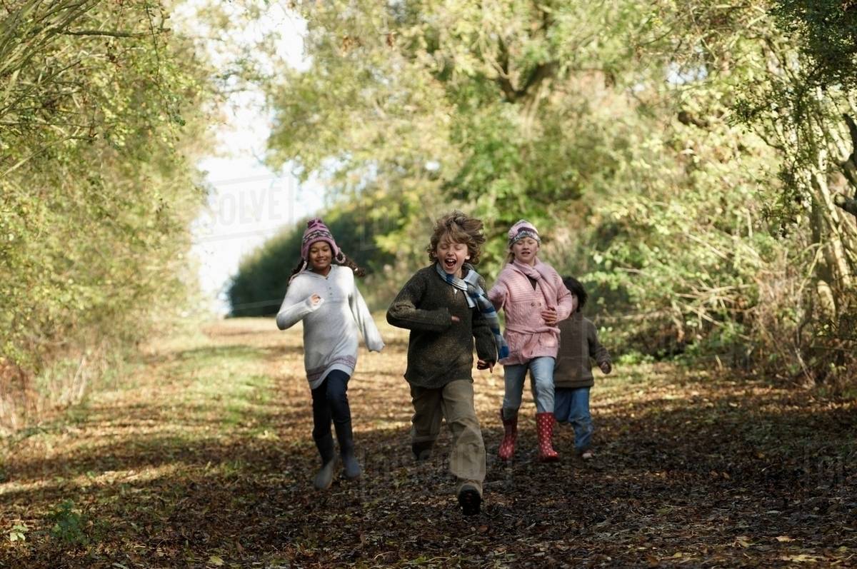 Children running down country lane - Royalty-free Stock Photo | Dissolve
