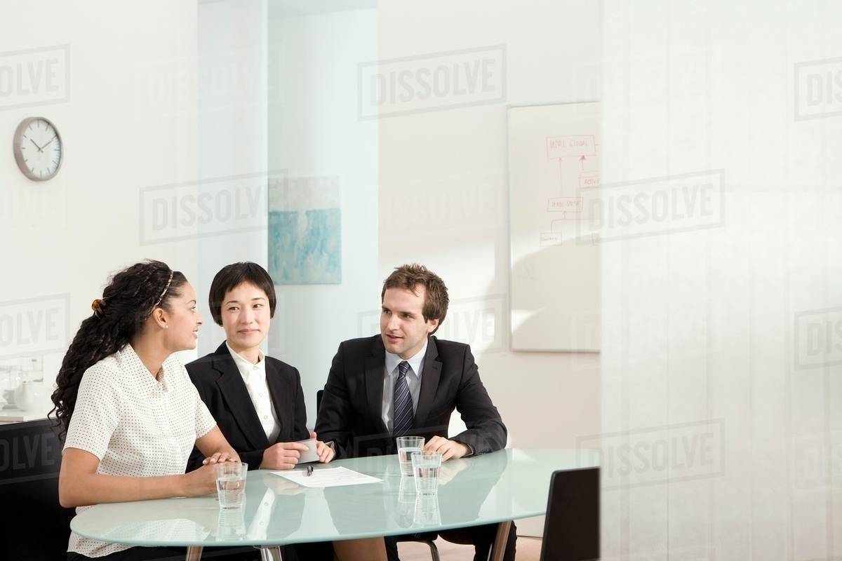 Three colleagues talking - Stock Photo - Dissolve