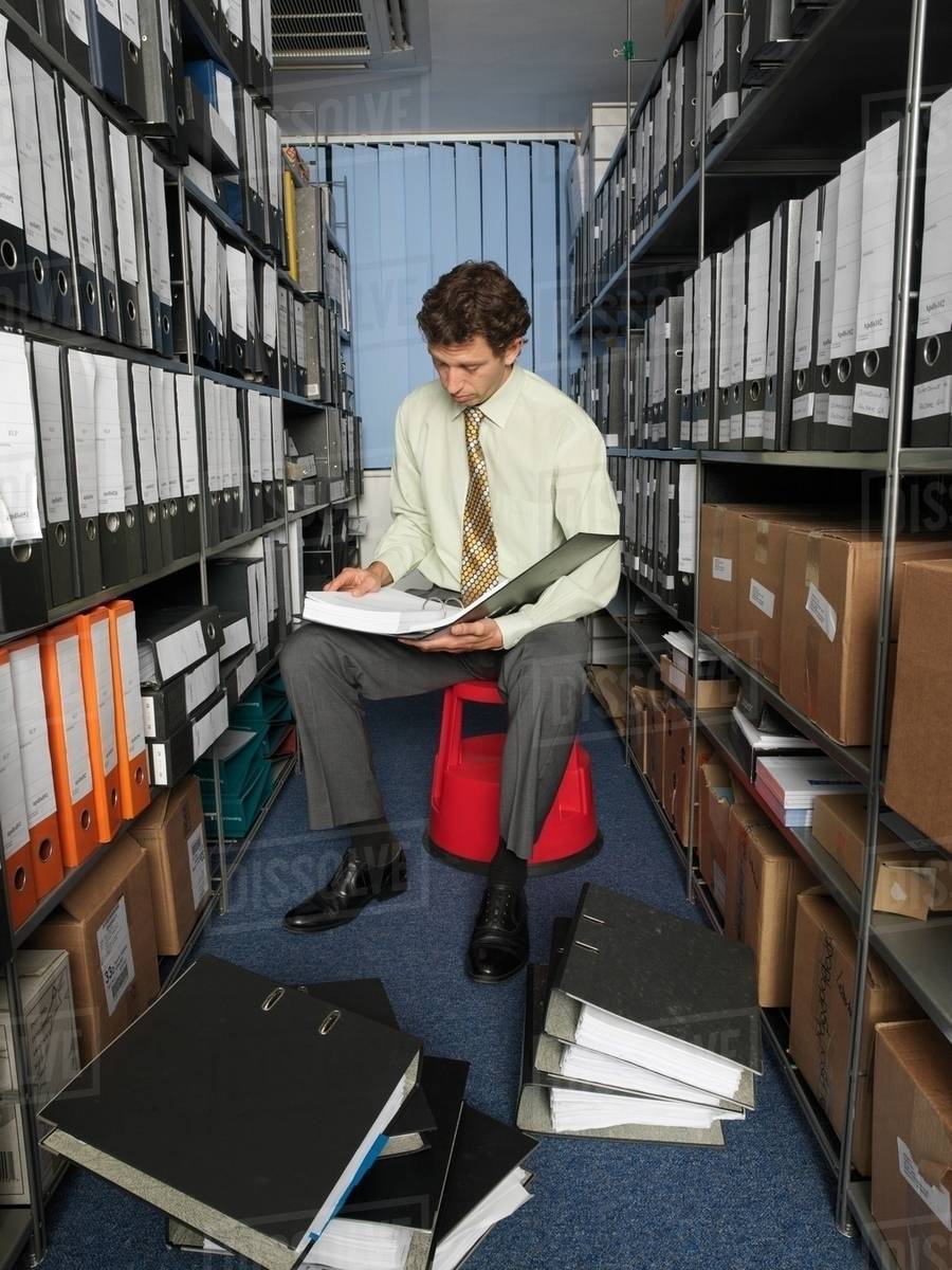 Office worker surrounded by files - Royalty-free Stock Photo | Dissolve