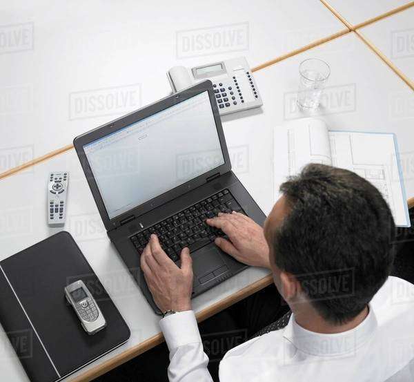Businessman using laptop - Stock Photo - Dissolve