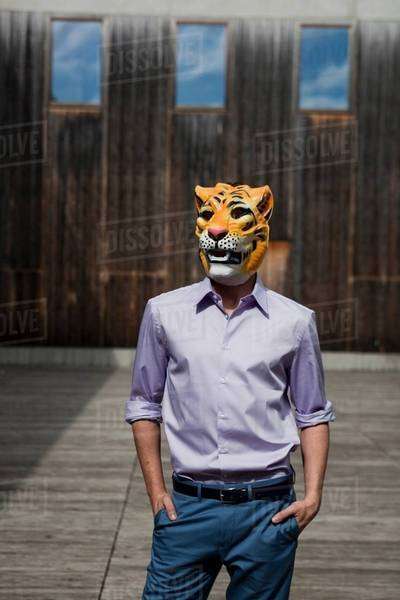 Man wearing tiger mask outdoor - Royalty-free Stock Photo | Dissolve
