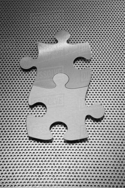 Metal jigsaw puzzle pieces - Stock Photo - Dissolve