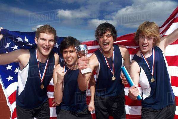 Relay team with flag and medal - Stock Photo - Dissolve